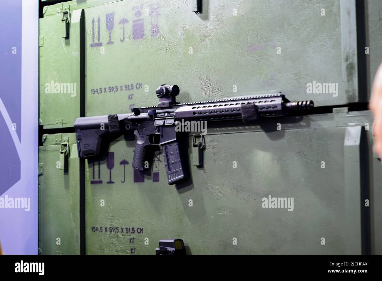An assault rifle hangs on a weapon crate Stock Photo - Alamy