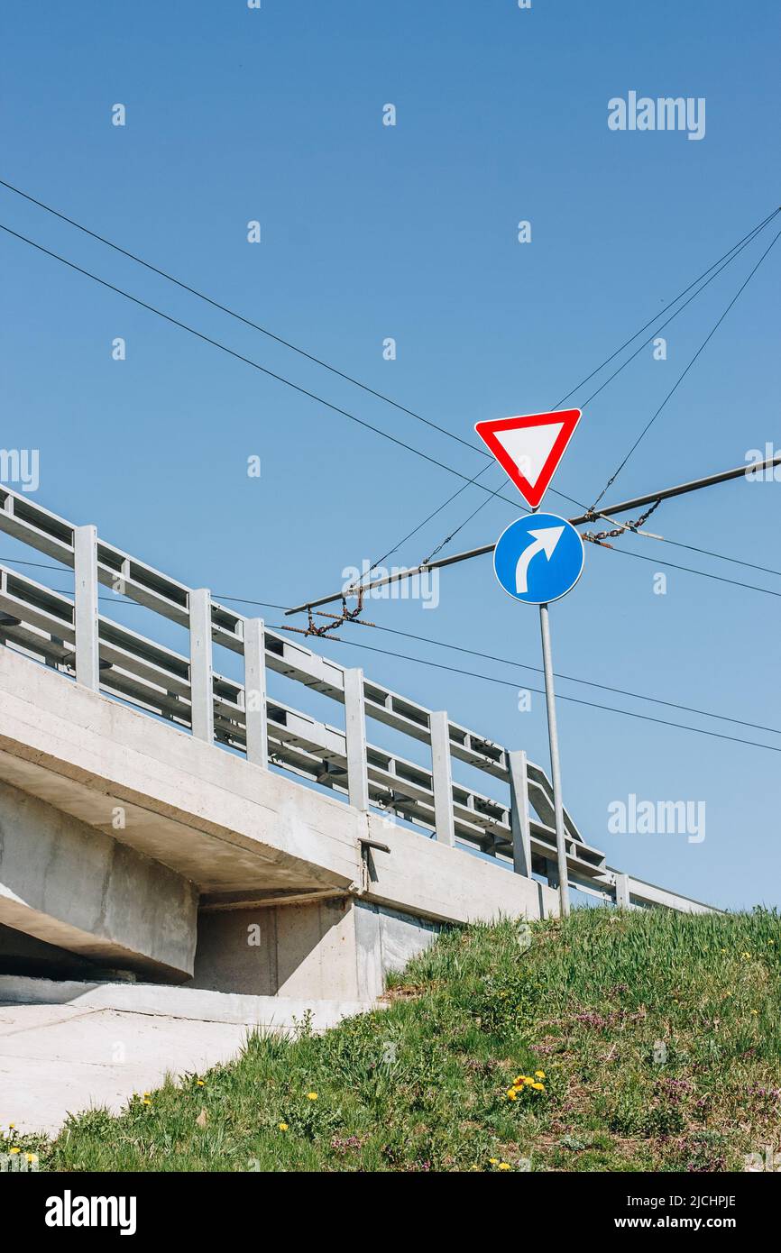 View of the concrete bridge next to the road. Visible - give way - sign ...