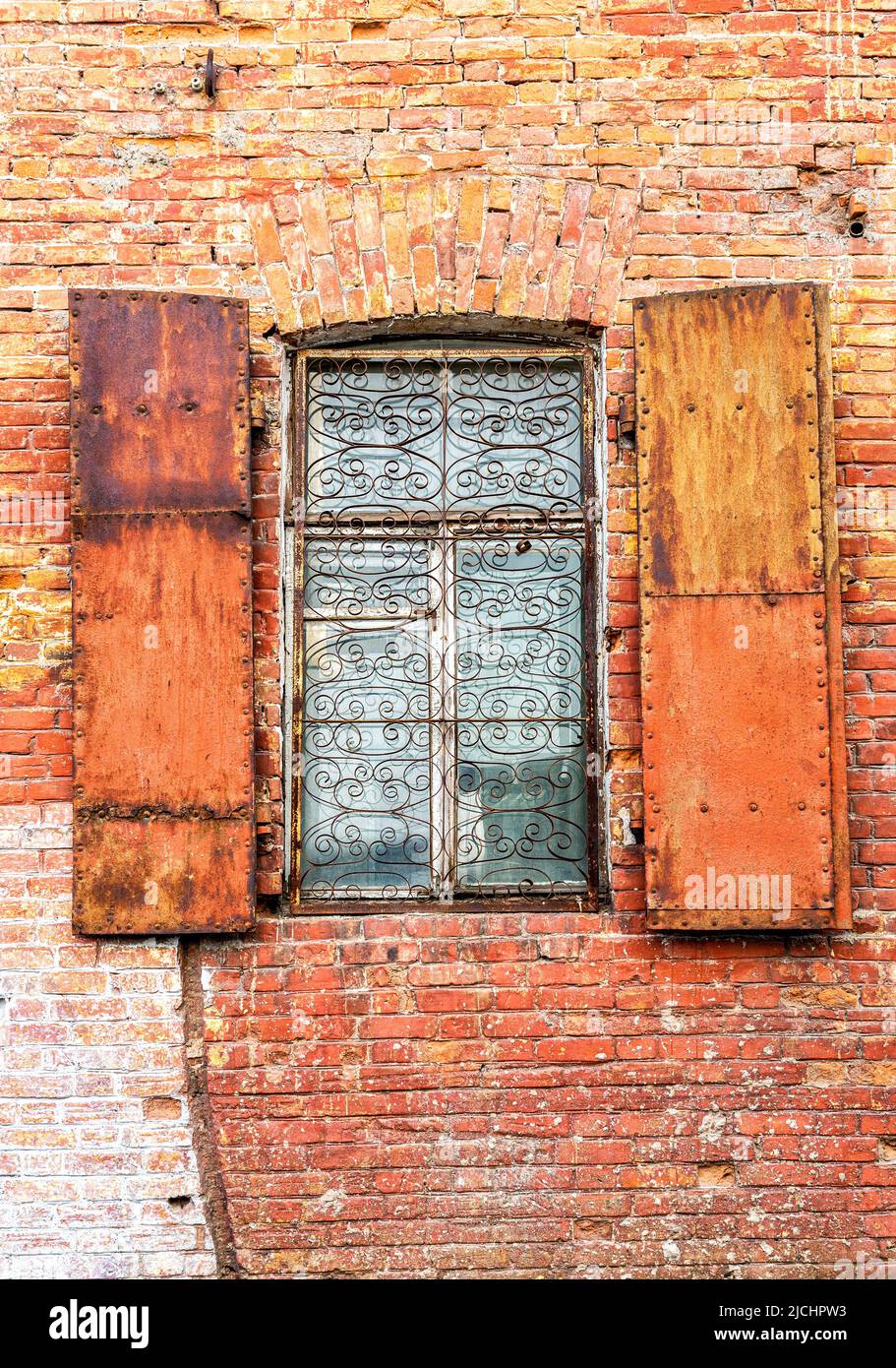 Old building brick wall with an window with hinged shutters. Windows of ...