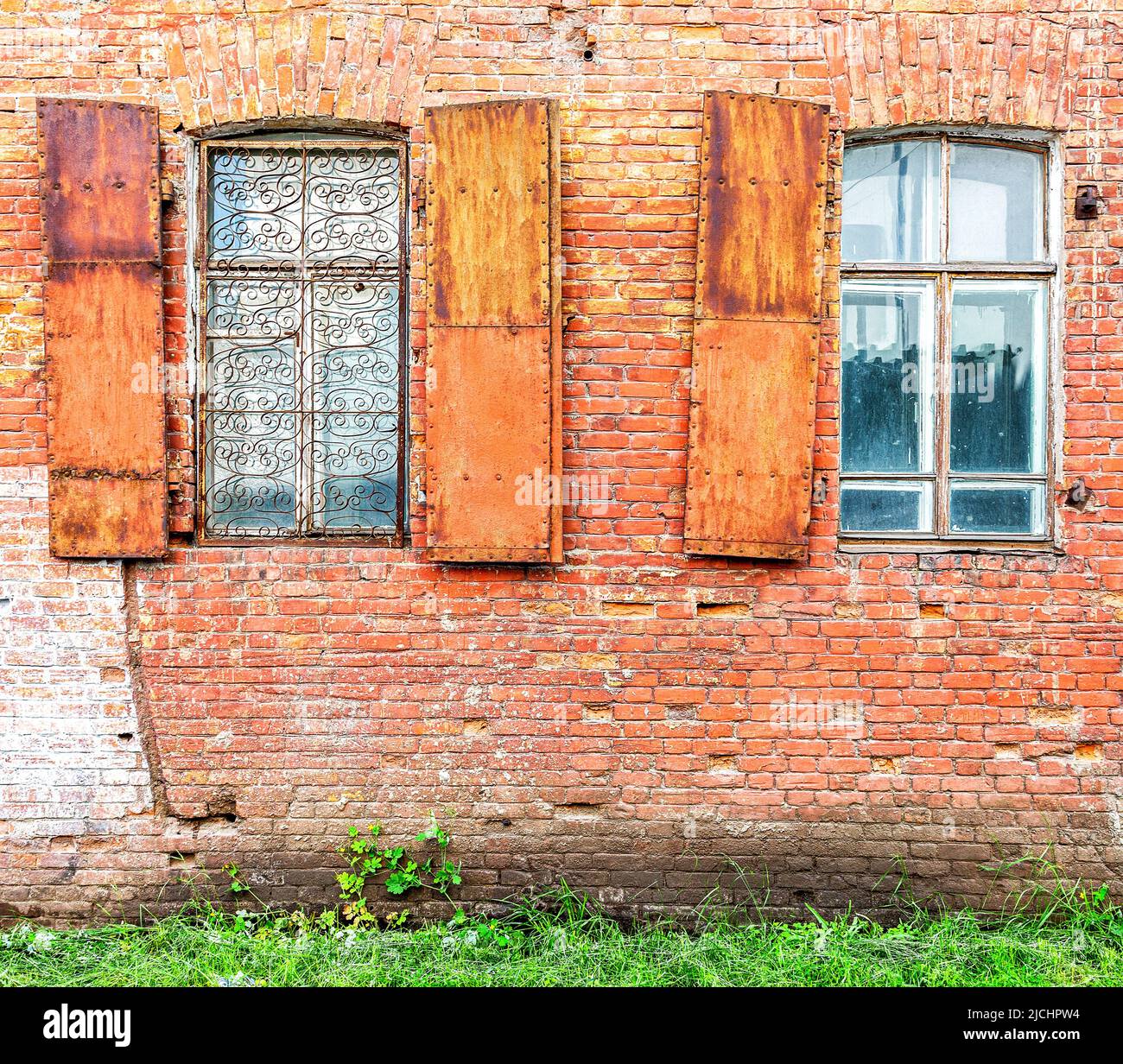 Old building brick wall with an window with hinged shutters. Windows of ...