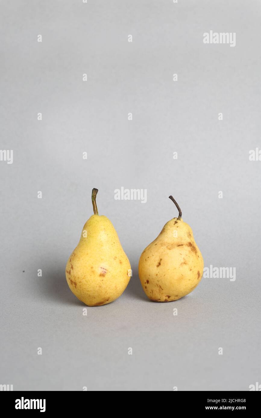 healthy eating concept - two pears isolated on gray background Stock ...