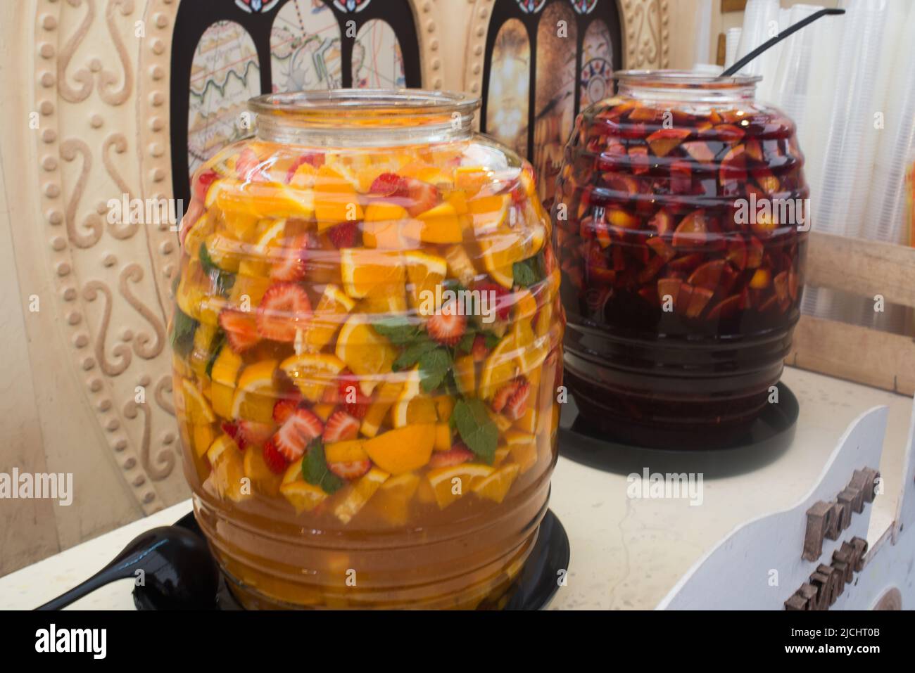 Refreshing drinks with natural fruit in two elegant glass containers ...