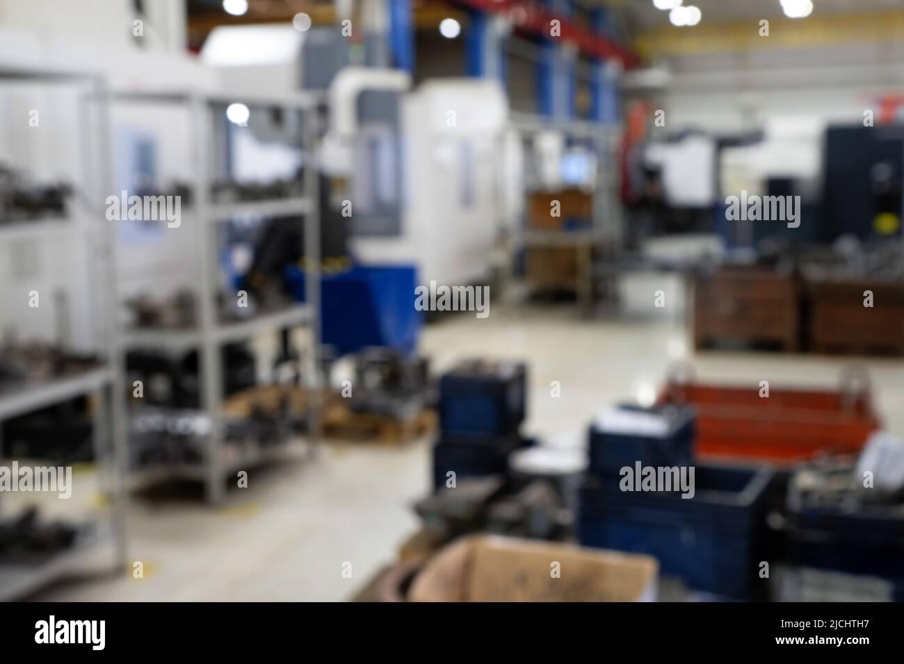 Defocused image of assembly room at big industrial plant manufacturing ...