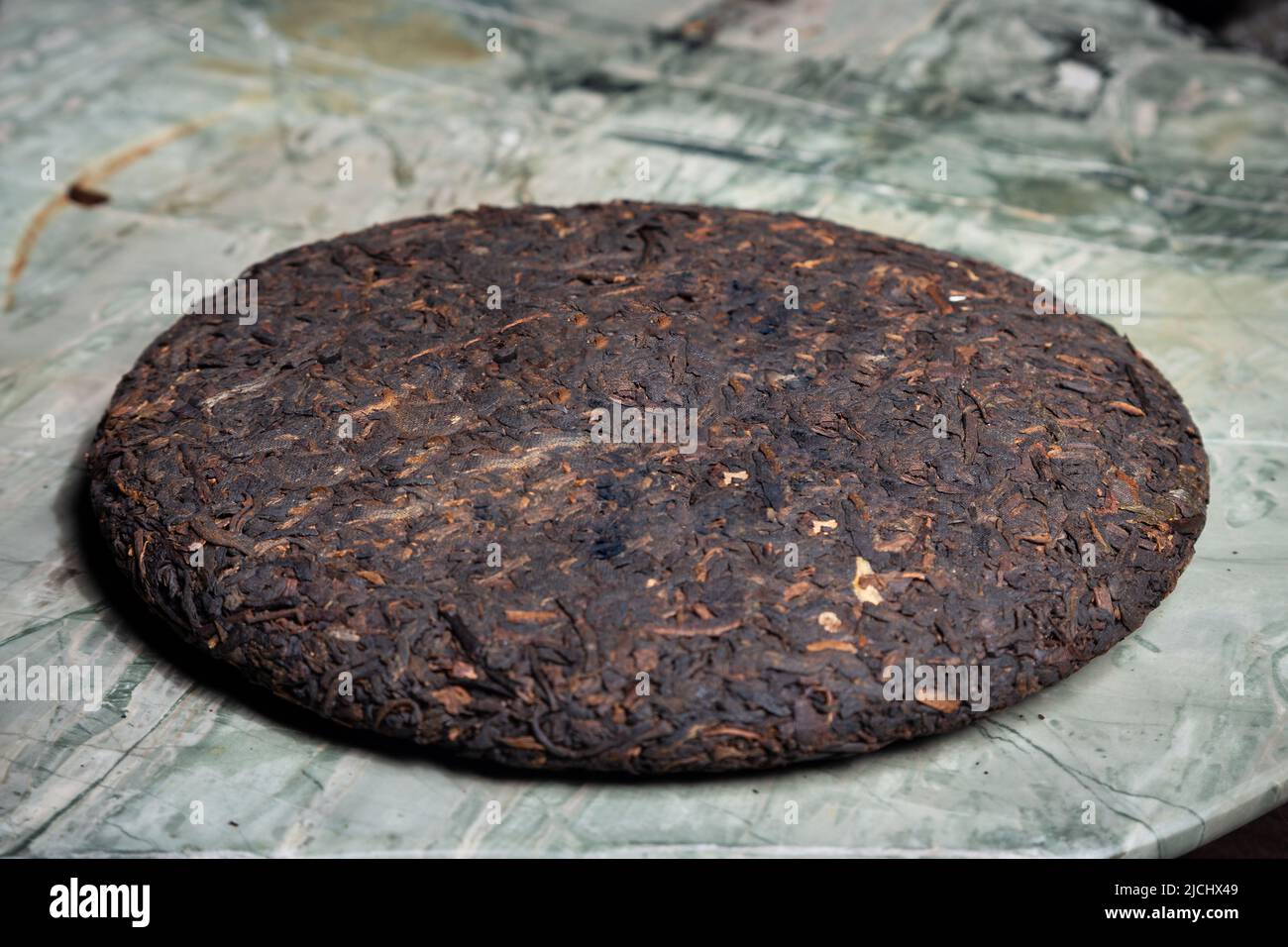 Pu-erh fermented Chinese tea in a roll Stock Photo - Alamy