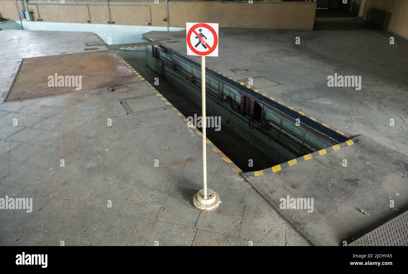 car repair pit with a warning sign, dangerous Stock Photo - Alamy