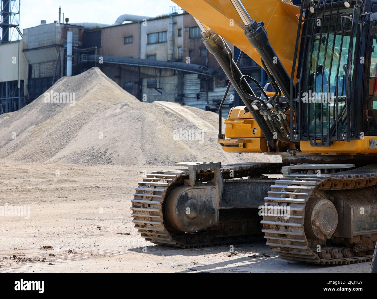Heavy industrial machinery in front of a factory Stock Photo - Alamy