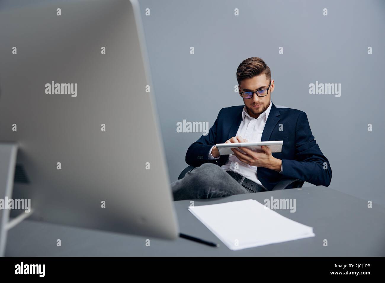 businessmen wearing glasses works in front of a computer isolated background Stock Photo - Alamy