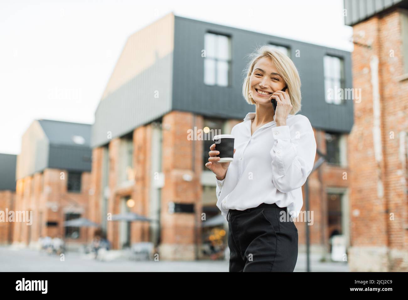 Portrait of beautiful blond woman having cup of fresh take away ...
