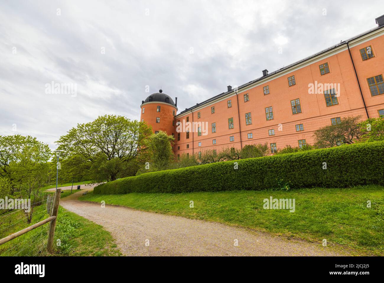 Beautiful exterior view of famous Uppsala Castle. Green plants and ...