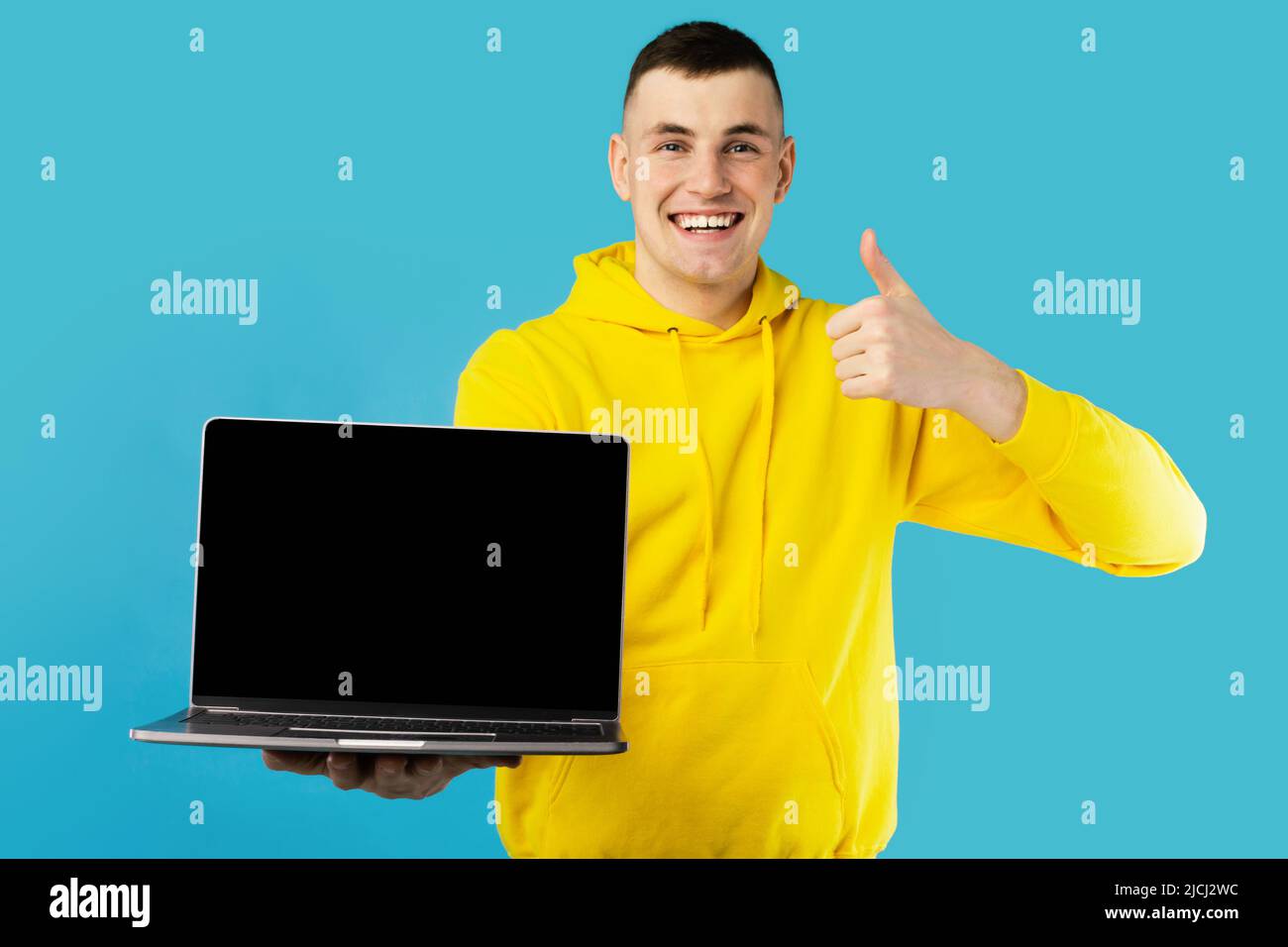 Guy Showing Laptop Blank Screen Gesturing Thumbs Up, Blue Background ...