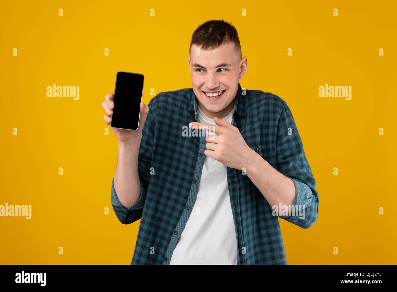 Funny Millennial Man Showing Cellphone Blank Screen On Yellow ...