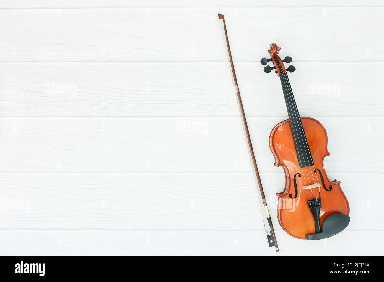 Violin and bow on white wood background. Flat lay, top view, copy space ...