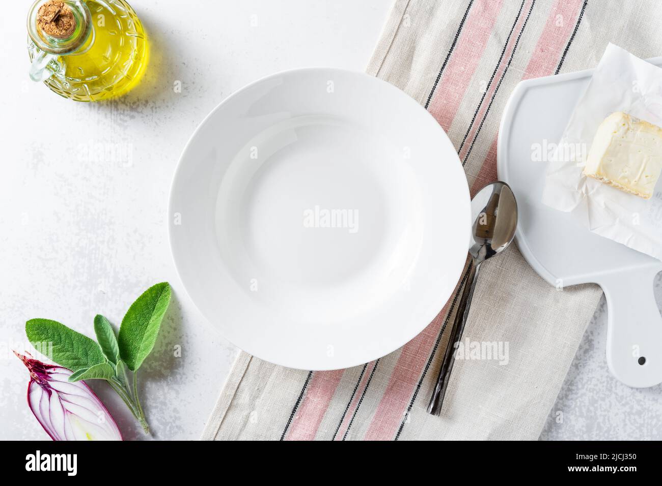 set of empty dishes on the table on a white background Stock Photo - Alamy