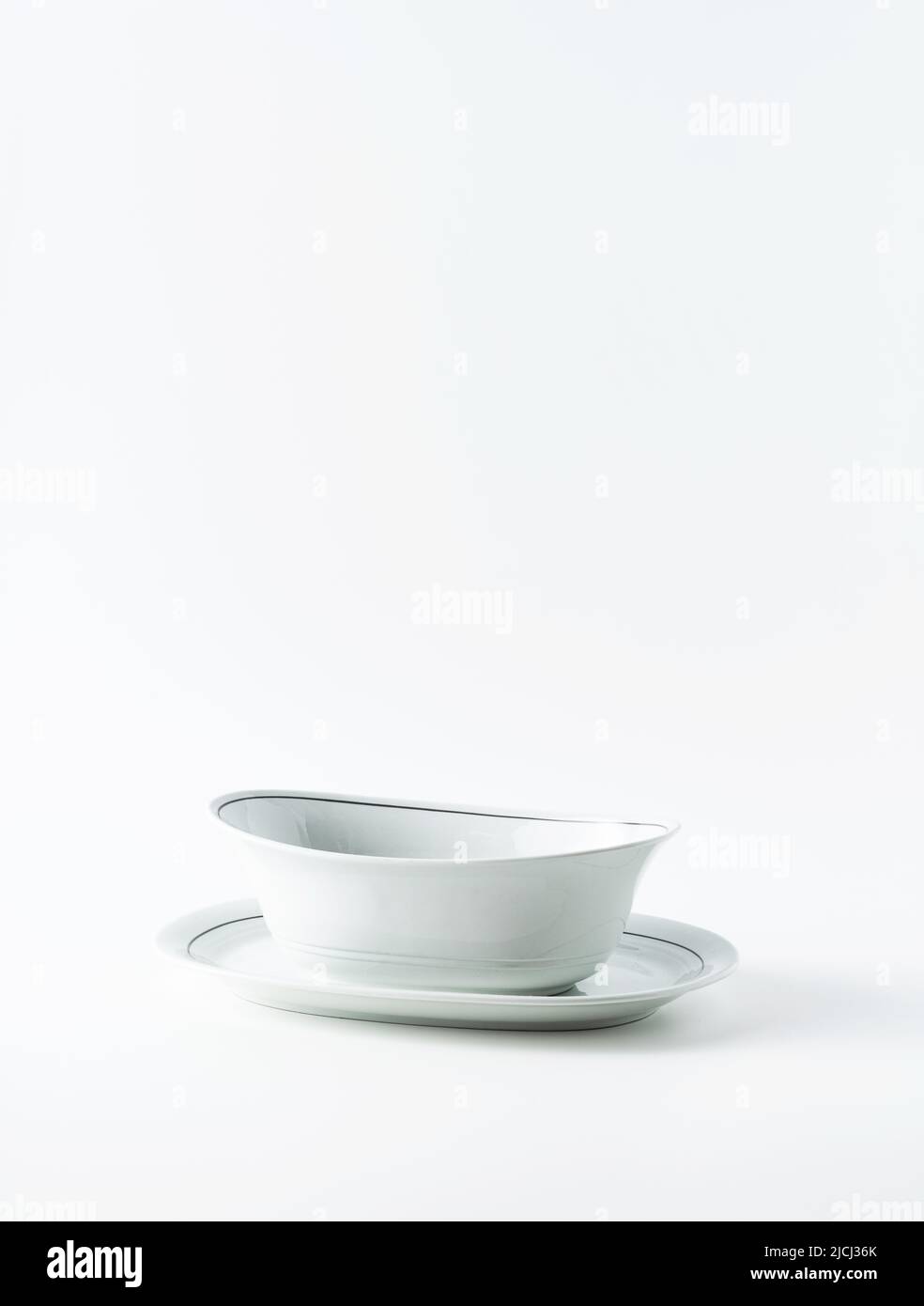 set of empty dishes on the table on a white background Stock Photo - Alamy