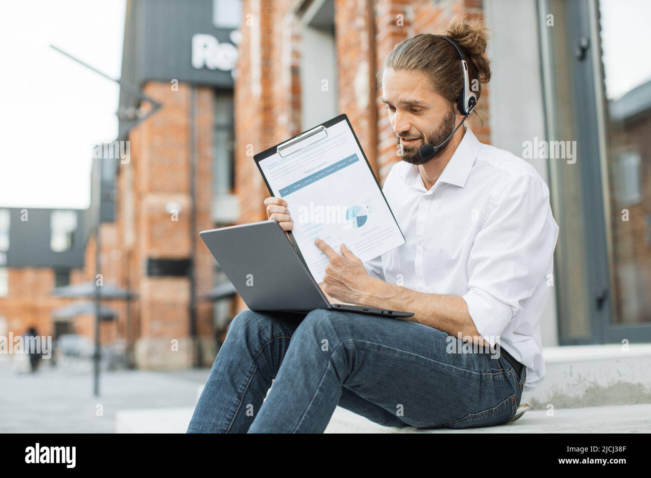 Focused attractive manager in headset leading working meeting through ...