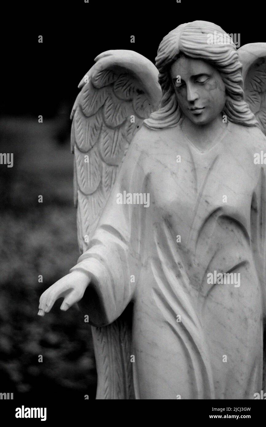 Cemetery statues edited in black and white Stock Photo - Alamy