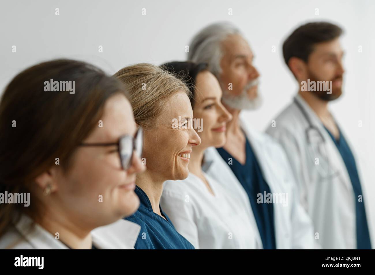 Group of professional doctors standing in a line at the modern clinic ...