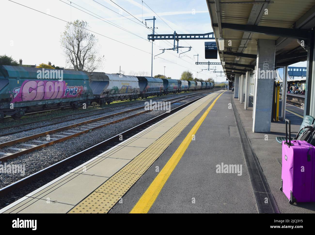 British railway platform with empty rails and suitcases waiting for a ...