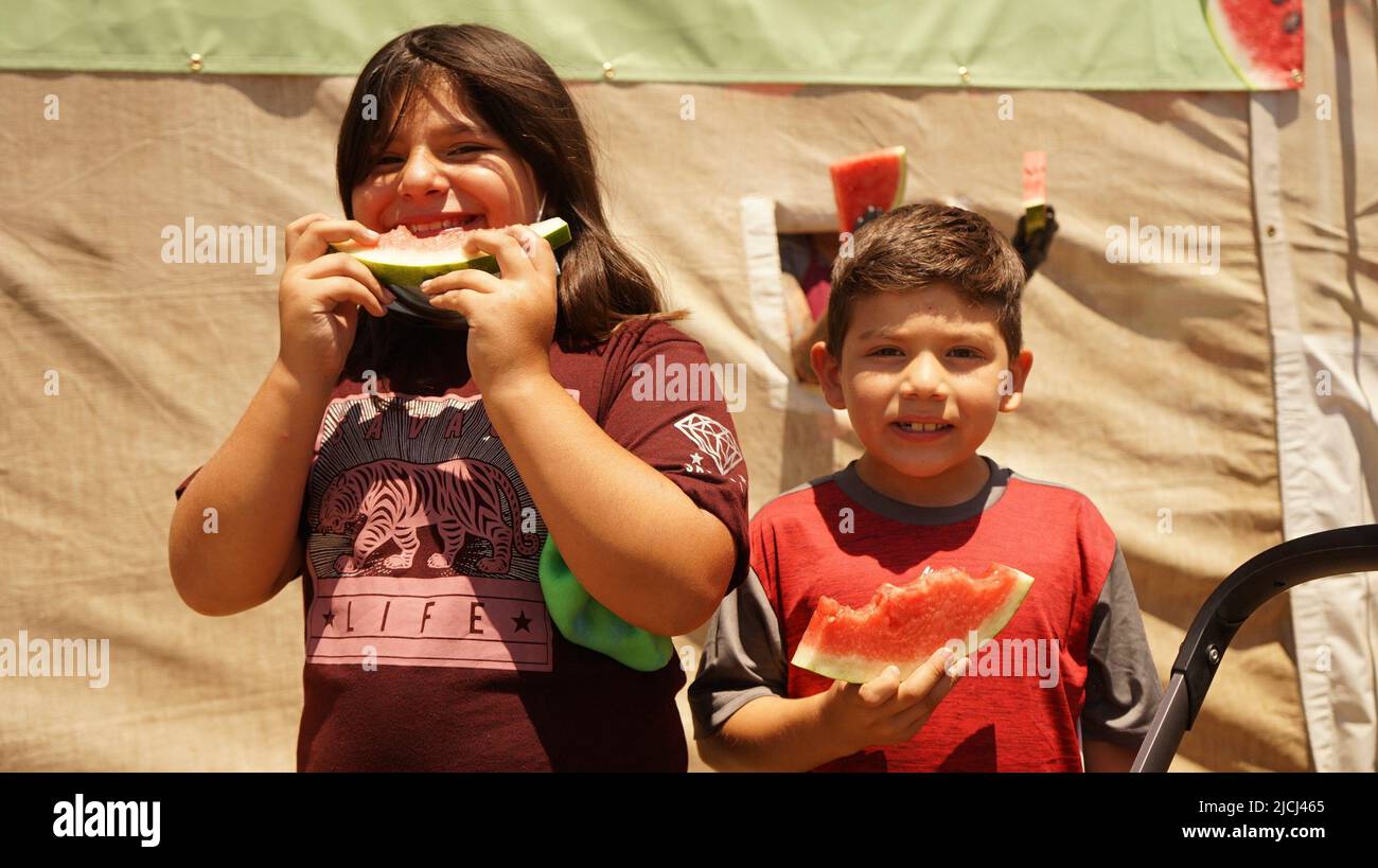 Los Angeles, USA. 12th June, 2022. Children enjoy watermelons at the ...