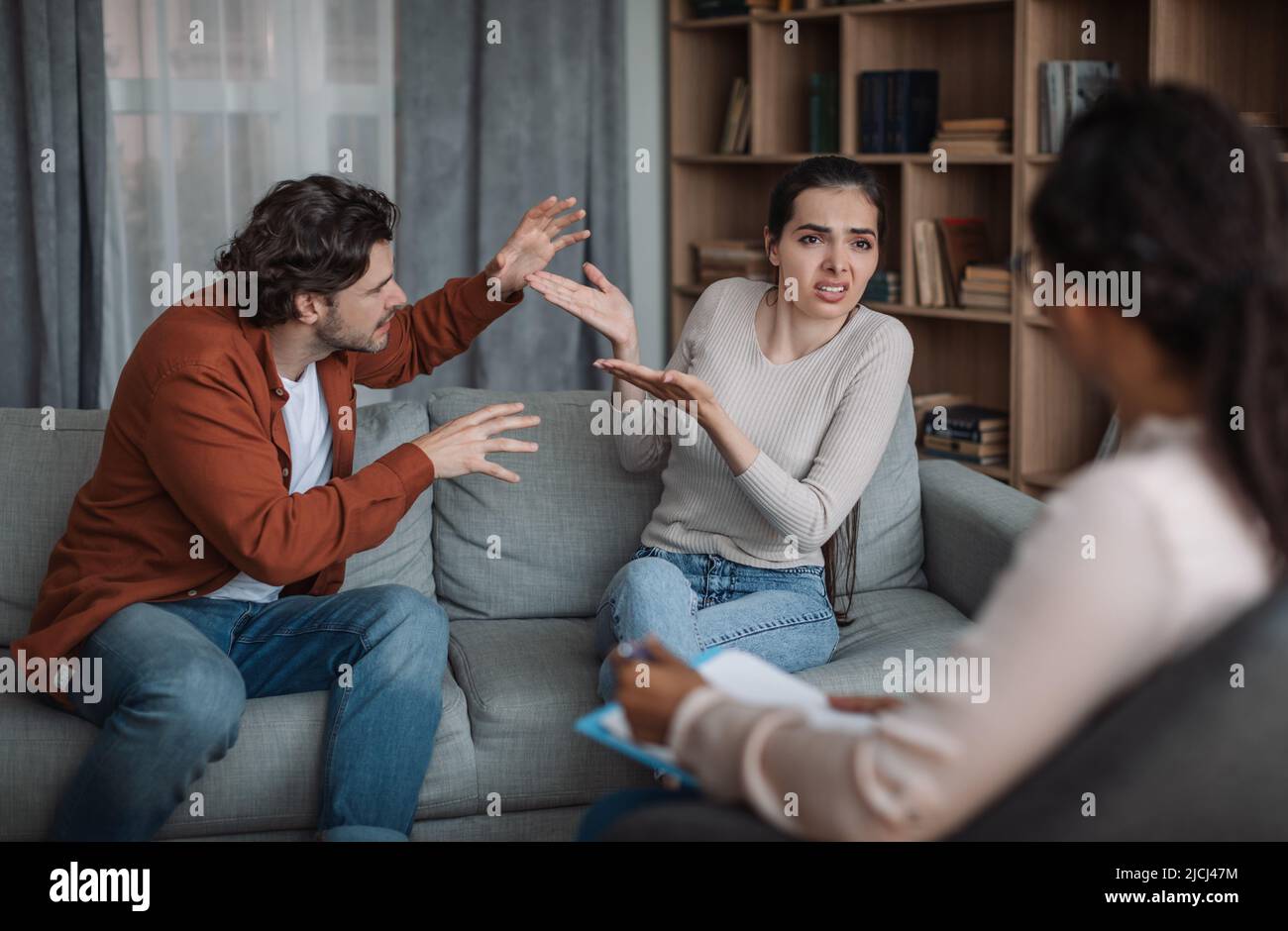 Angry unhappy millennial european husband and wife arguing at ...