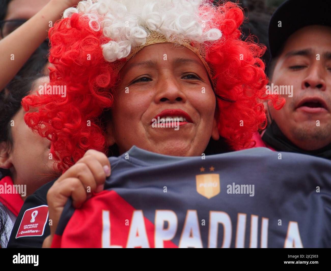 A woman wearing the colors of the Peruvian national team when fans of ...