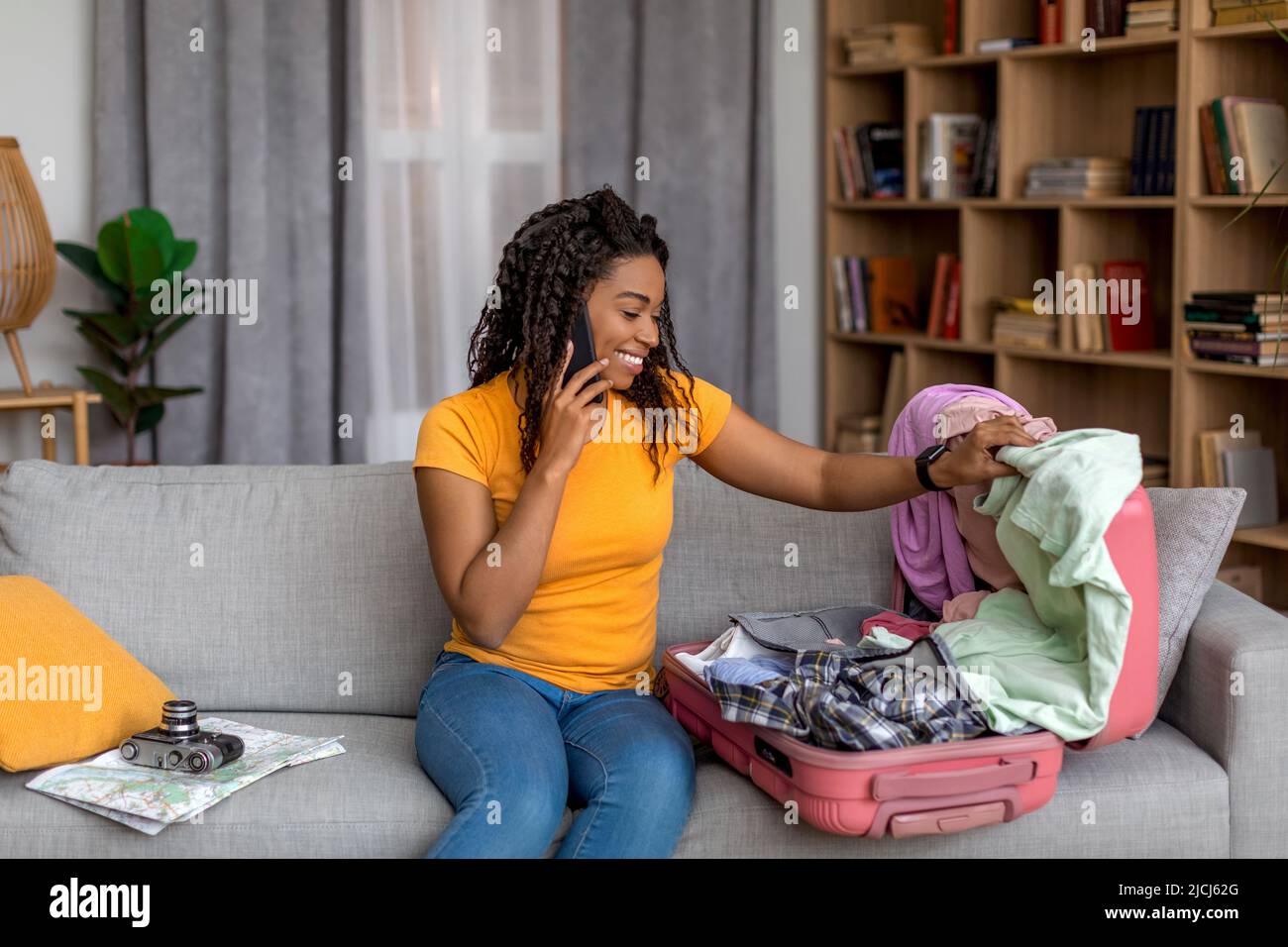 African woman packing suitcase hi-res stock photography and images - Alamy
