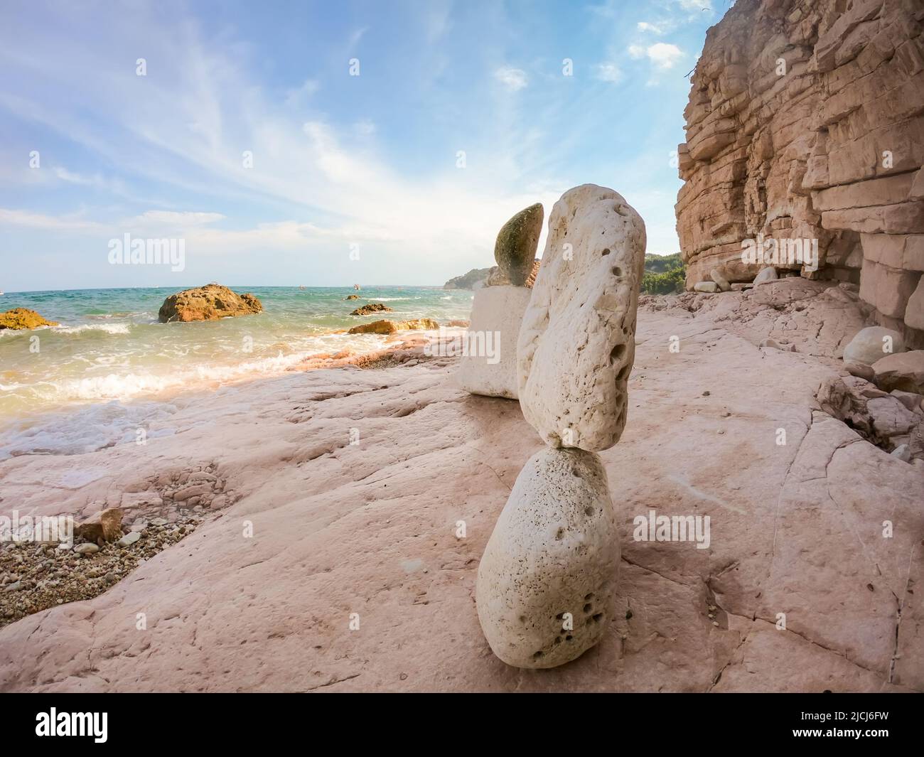 Pink stone balancing pyramid on the turquoise beach of Sassi Neri ...