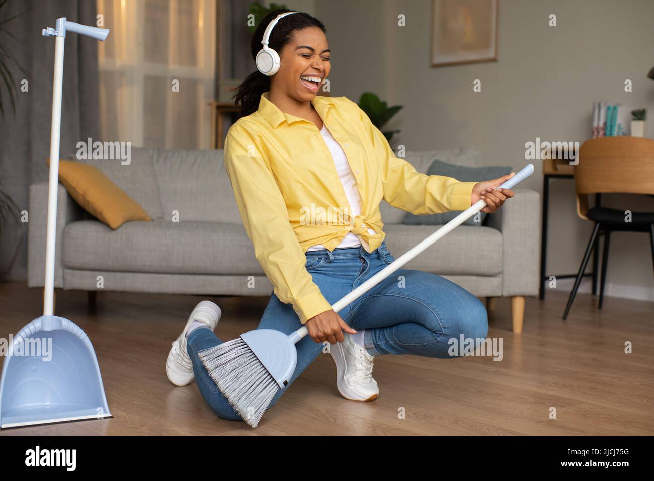 Black Lady Sweeping Floor Having Fun Pretending Playing Guitar Indoor ...