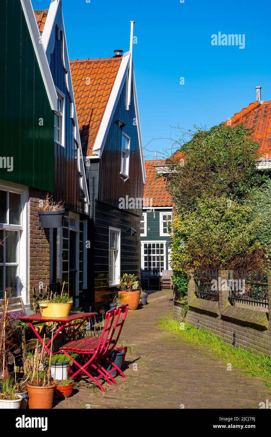 Walking on sunny spring day in small Dutch town Marken with wooden ...