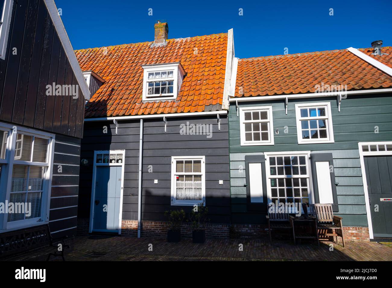 Walking on sunny spring day in small Dutch town Marken with wooden ...