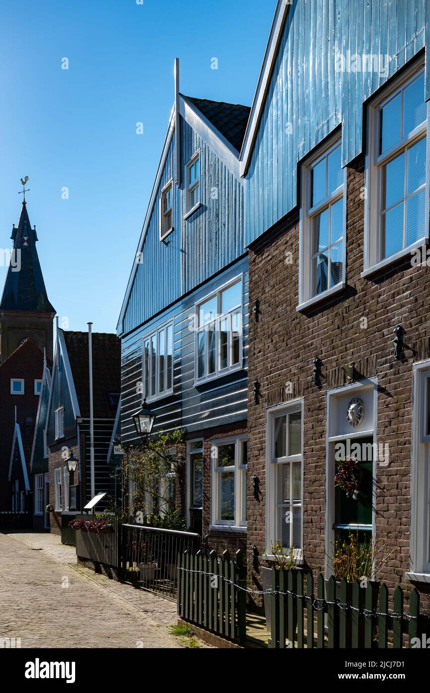 Walking on sunny spring day in small Dutch town Marken with wooden ...