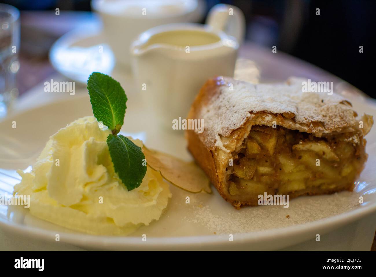 Austrian sweet dessert, portion of apple strudel with whippen cream and ...