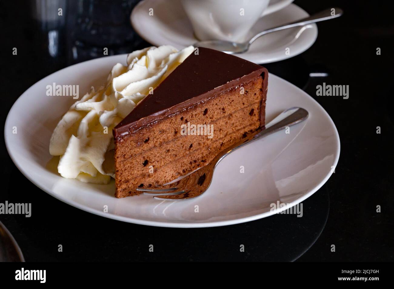 Piece of famous Sachertorte chocolate cake with apricot jam of Austrian ...