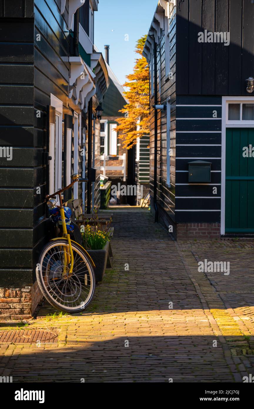 Walking on sunny spring day in small Dutch town Marken with wooden ...