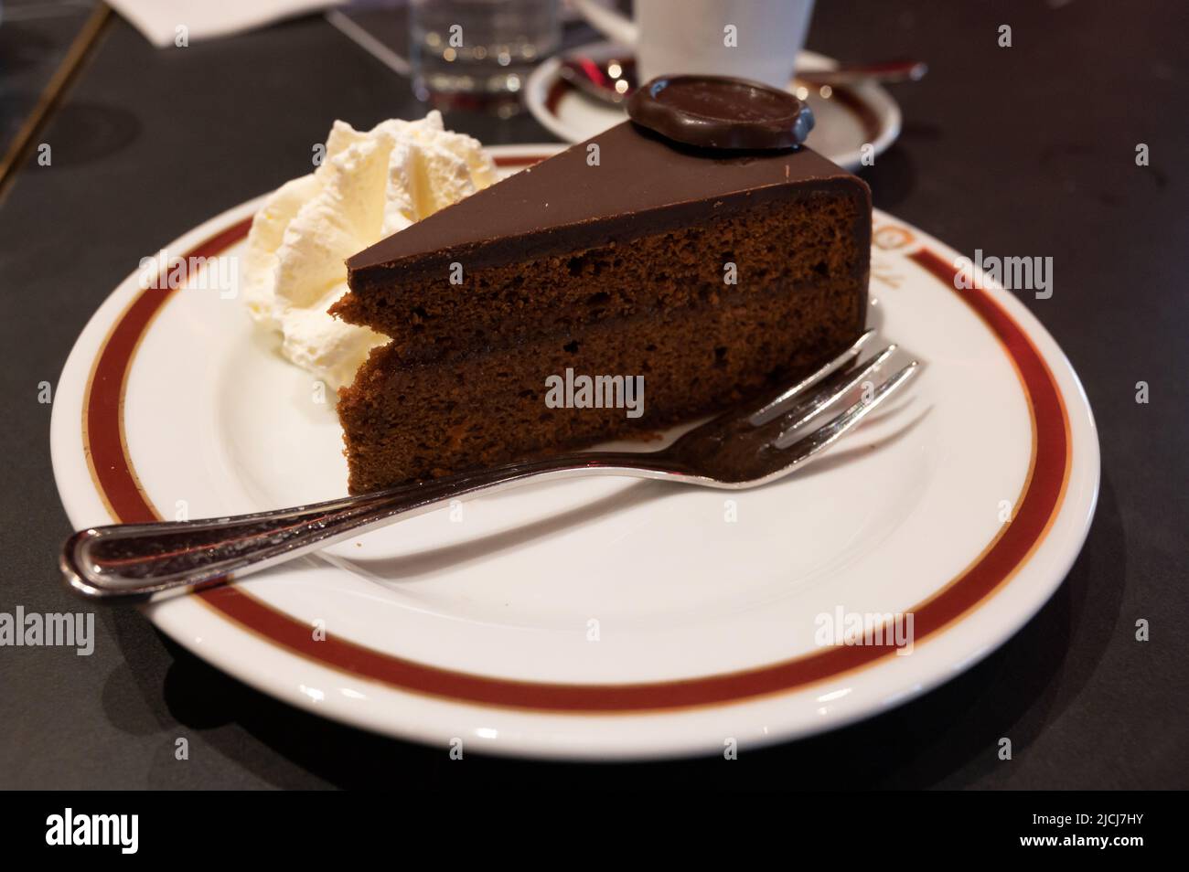 Piece of famous Sachertorte chocolate cake with apricot jam of Austrian ...