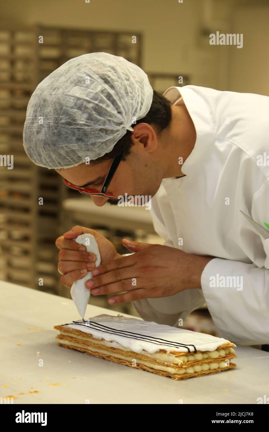 ISTANBUL, TURKEY - AUGUST 10: Turkish chef making cake in the baker ...