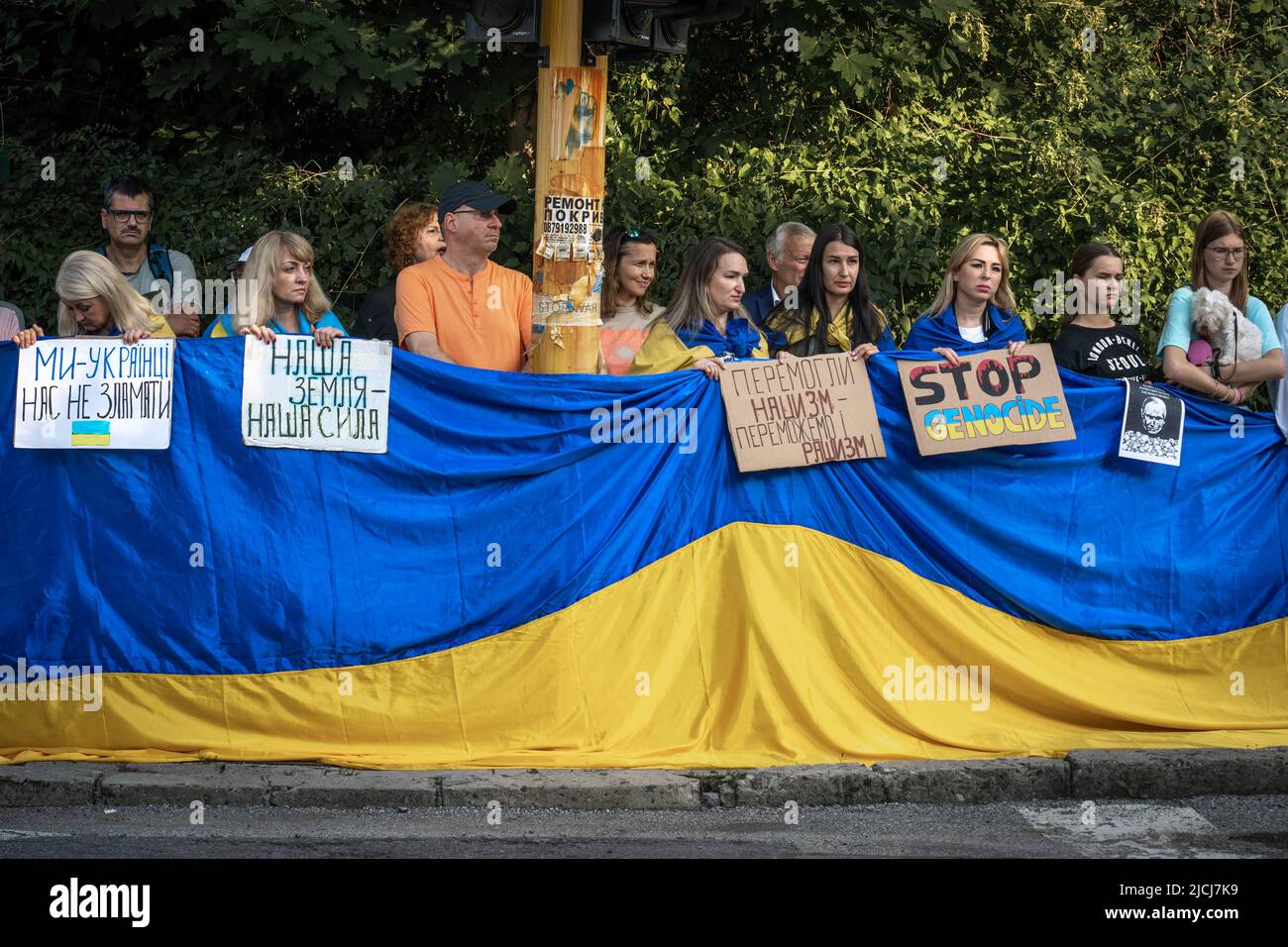 Sofia, Bulgaria, June 13, 2022: The people holding giant Ukrainian flag ...