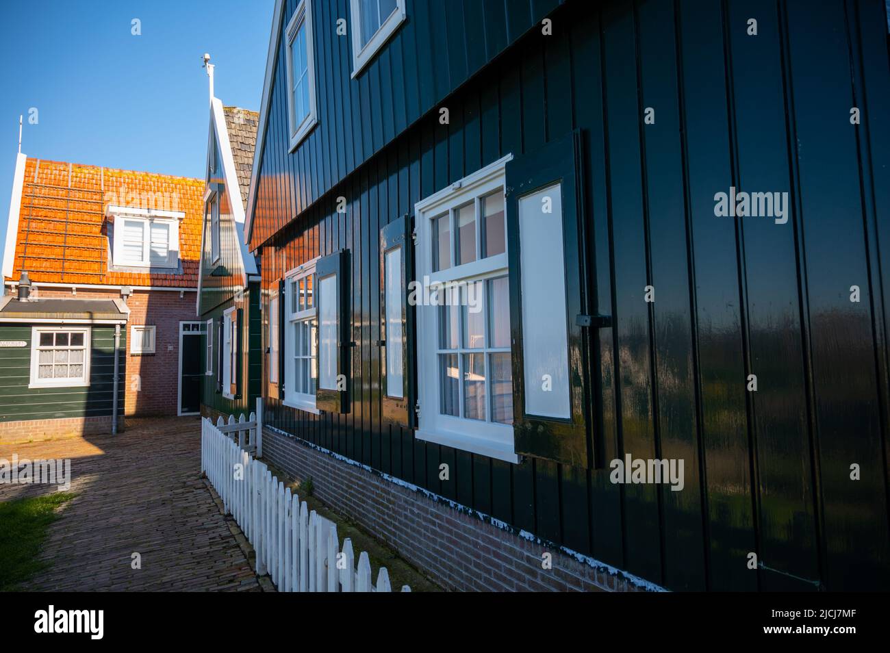 Walking on sunny spring day in small Dutch town Marken with wooden ...