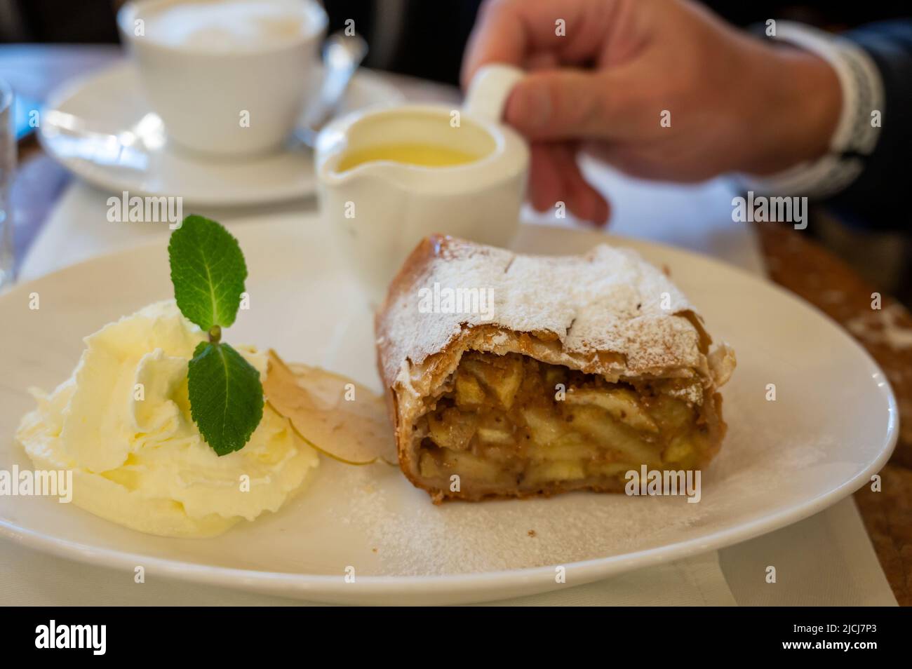 Austrian sweet dessert, portion of apple strudel with whippen cream and ...