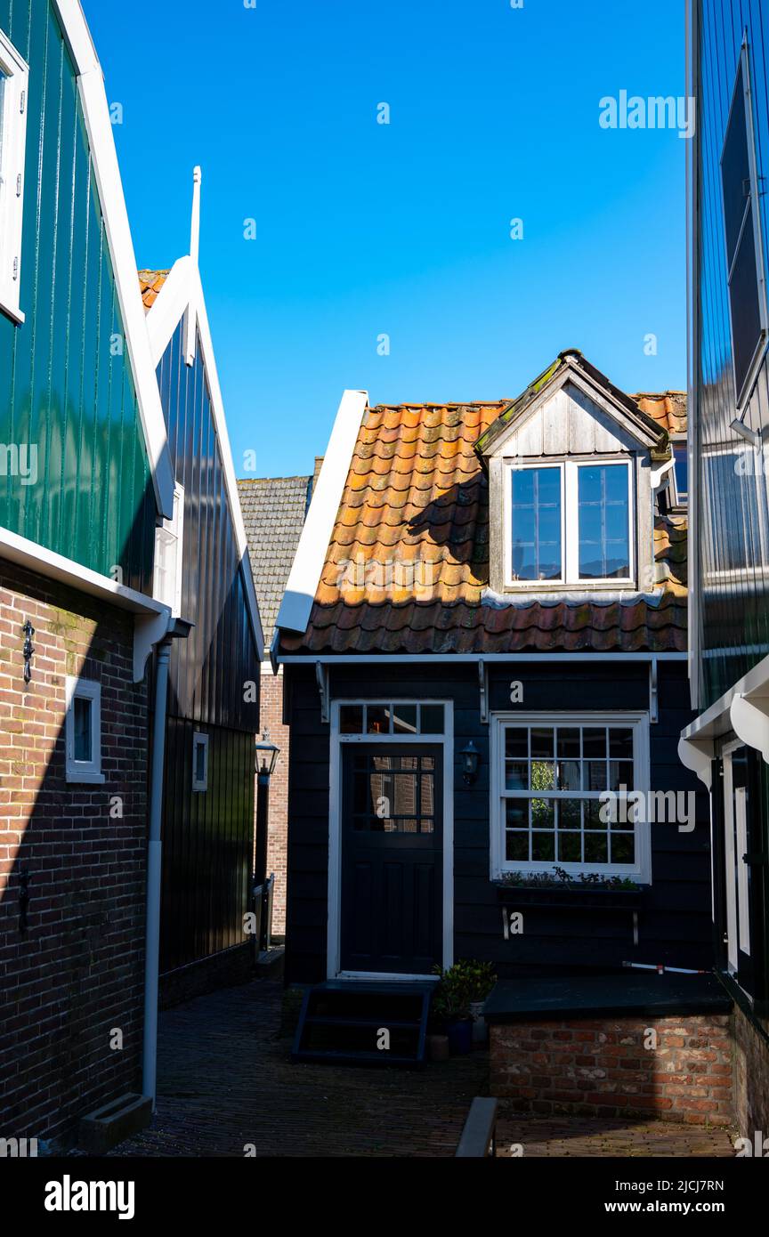 Walking on sunny spring day in small Dutch town Marken with wooden ...