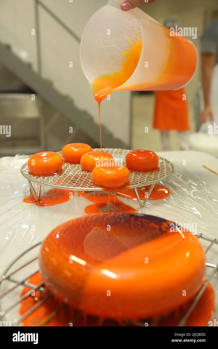 Chef making 'Orange cake' in the bakery shop Stock Photo - Alamy