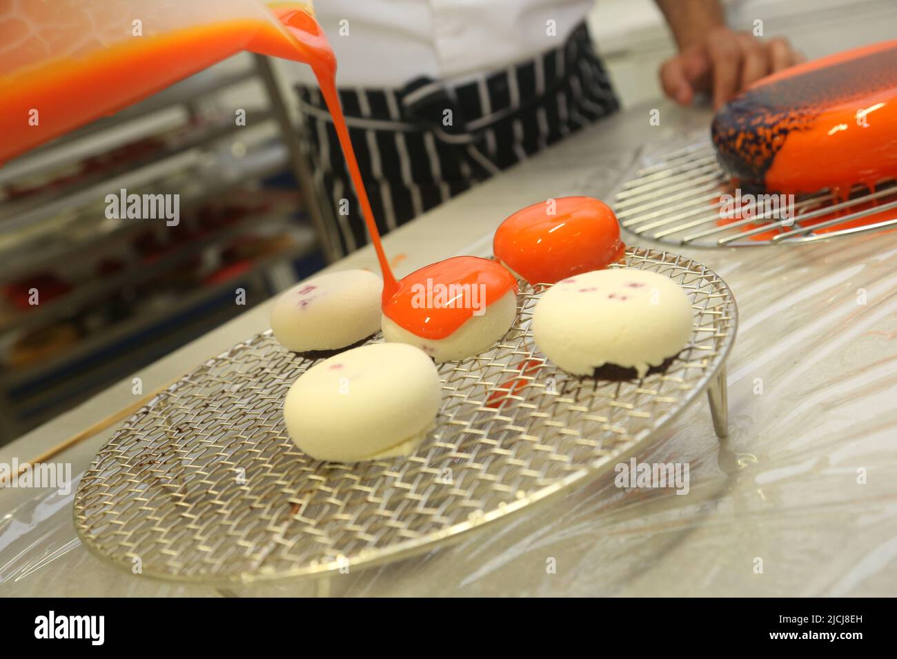 Chef making 'Orange cake' in the bakery shop Stock Photo - Alamy