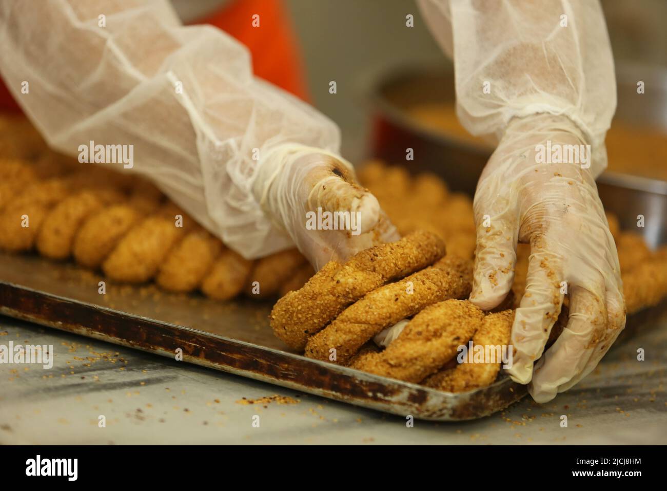 Chef making Turkish Bagel (Simit) in the baker factory Stock Photo - Alamy