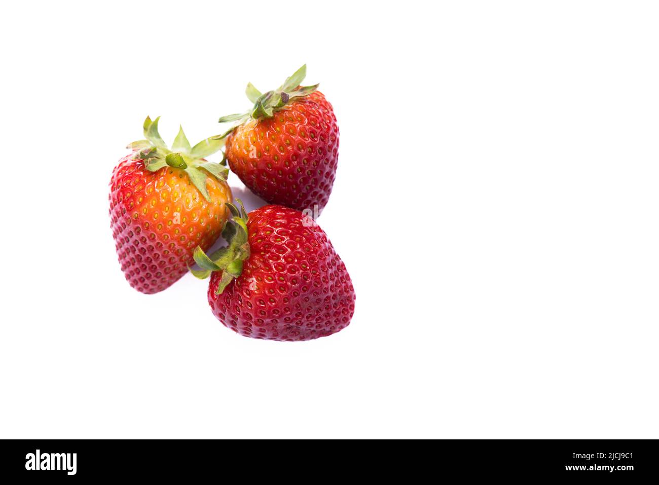 Three strawberries isolated on a white background Stock Photo - Alamy