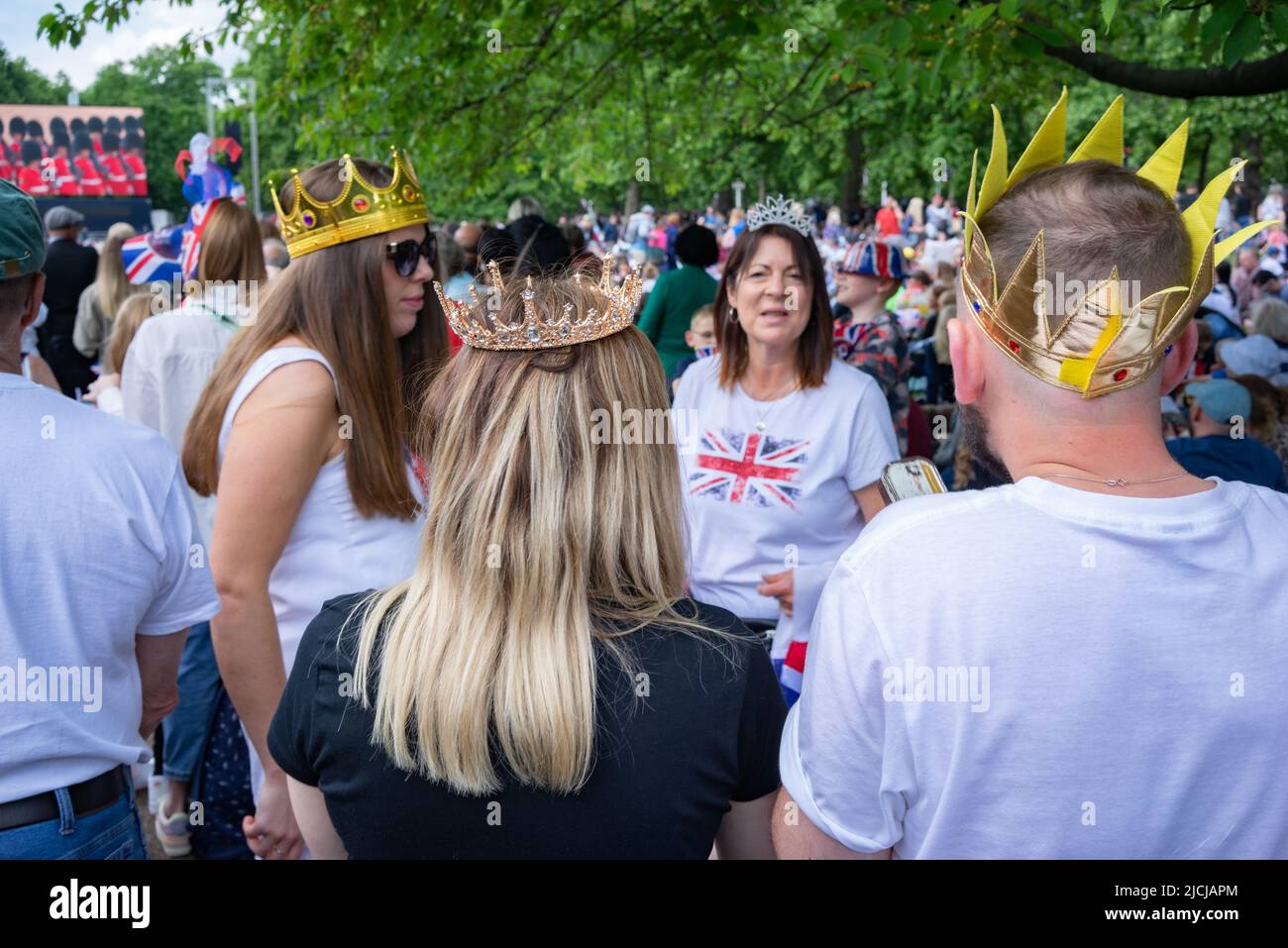 Crowd wearing crowns in St James Park, London, England watching The ...