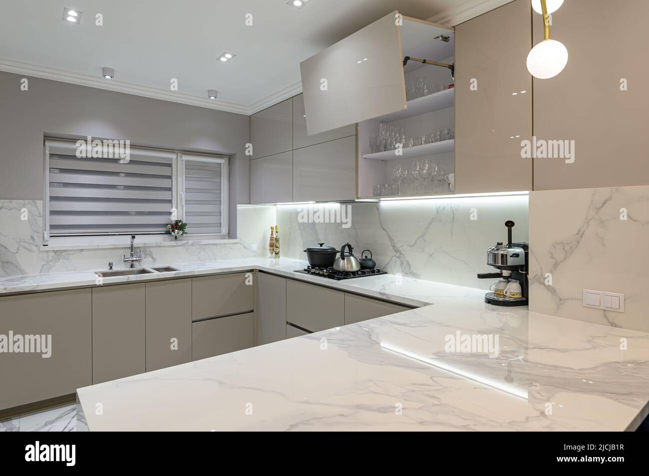 Luxury white modern marble kitchen in studio space Stock Photo - Alamy