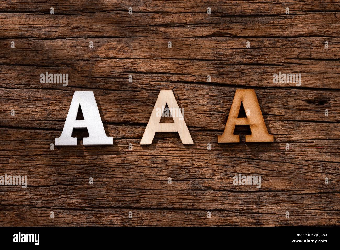 Three times the letter A - Rustic background Stock Photo - Alamy