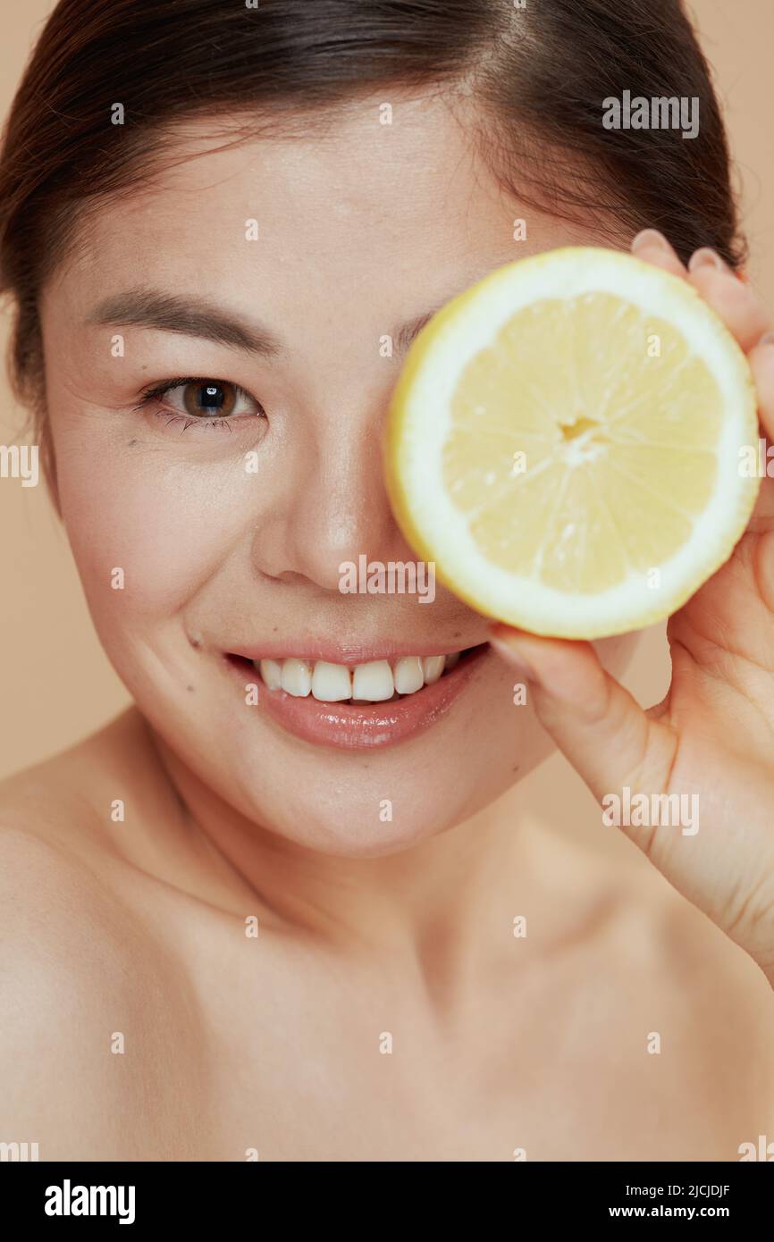 modern woman with lemon isolated on beige background Stock Photo - Alamy