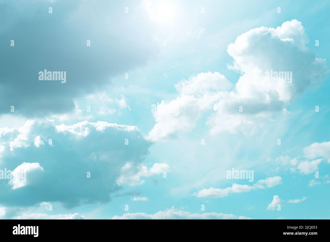 Sky.Clouds and sunshine. White clouds and sun rays in a blue sky ...