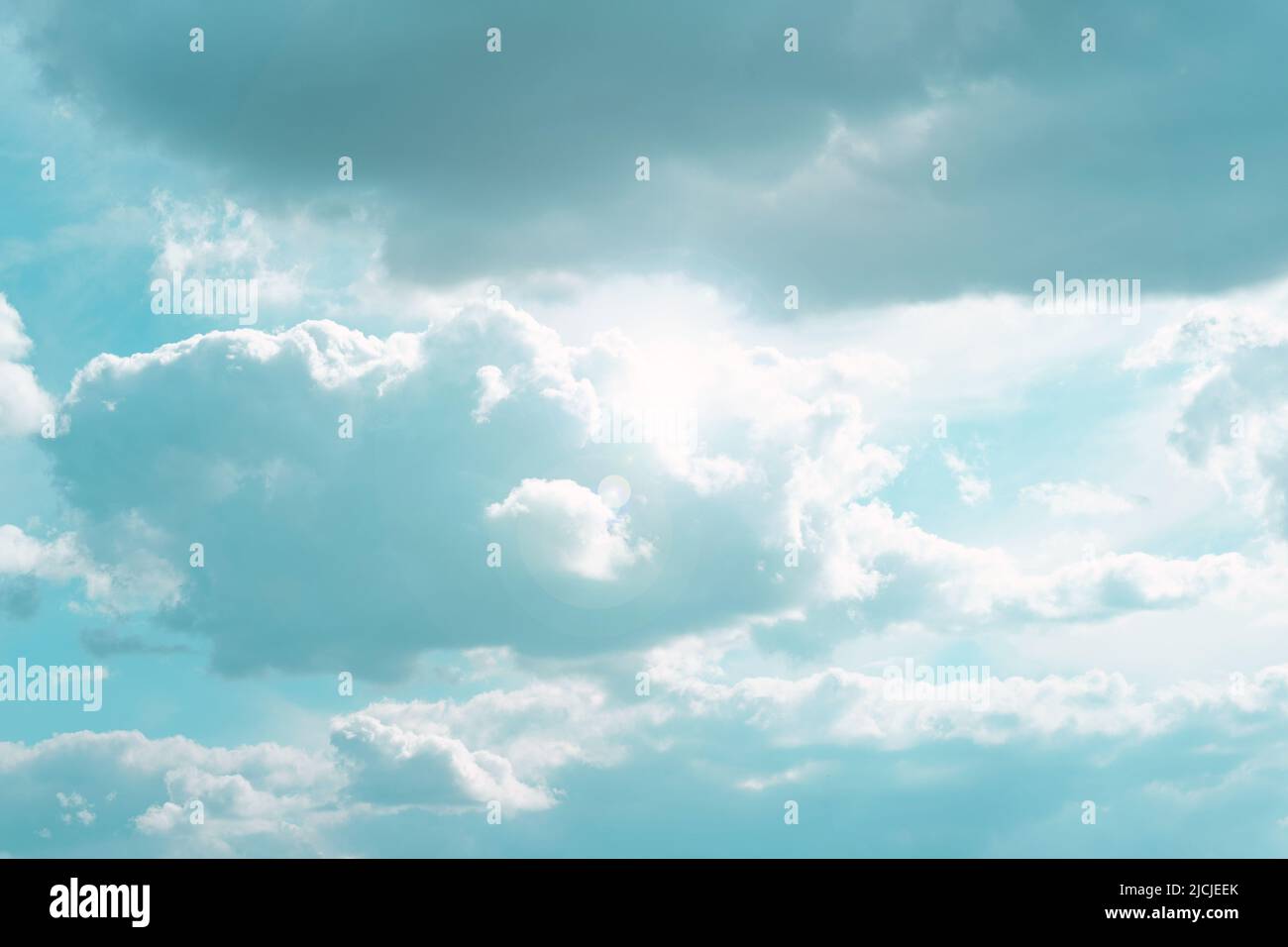 White clouds and sun rays in a sky.Beautiful heavenly wallpaper in blue ...